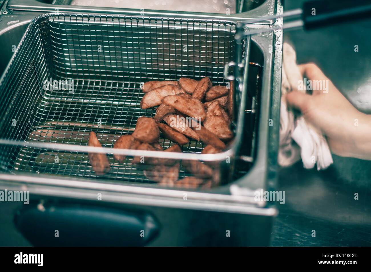 close up. Female chef preparing french fries in kitchen Stock Photo - Alamy