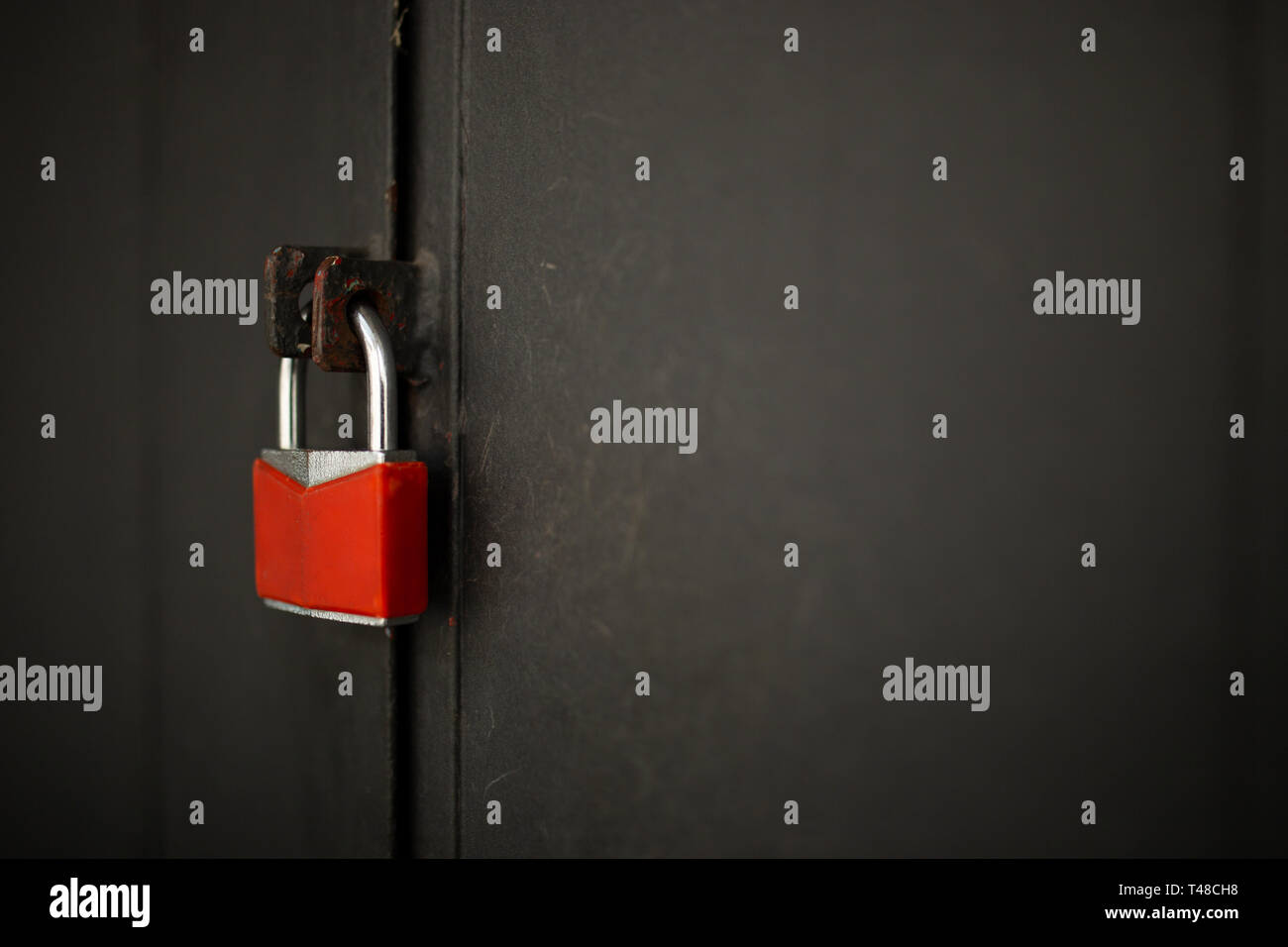 A red lock on the iron door Stock Photo - Alamy