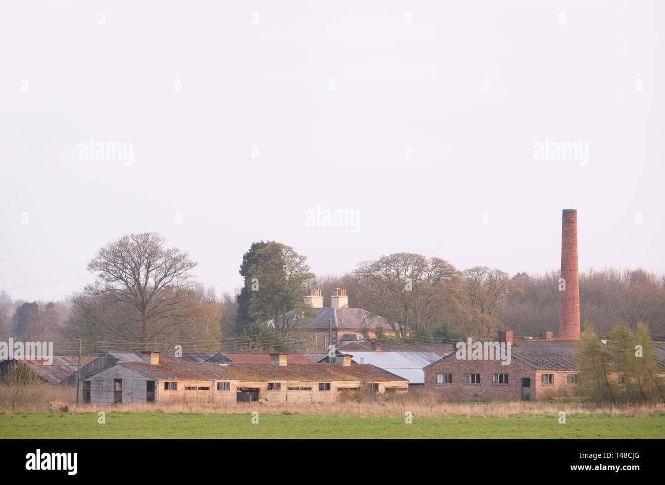 Farm building and industrial chimney for steam engine machinery in mill ...