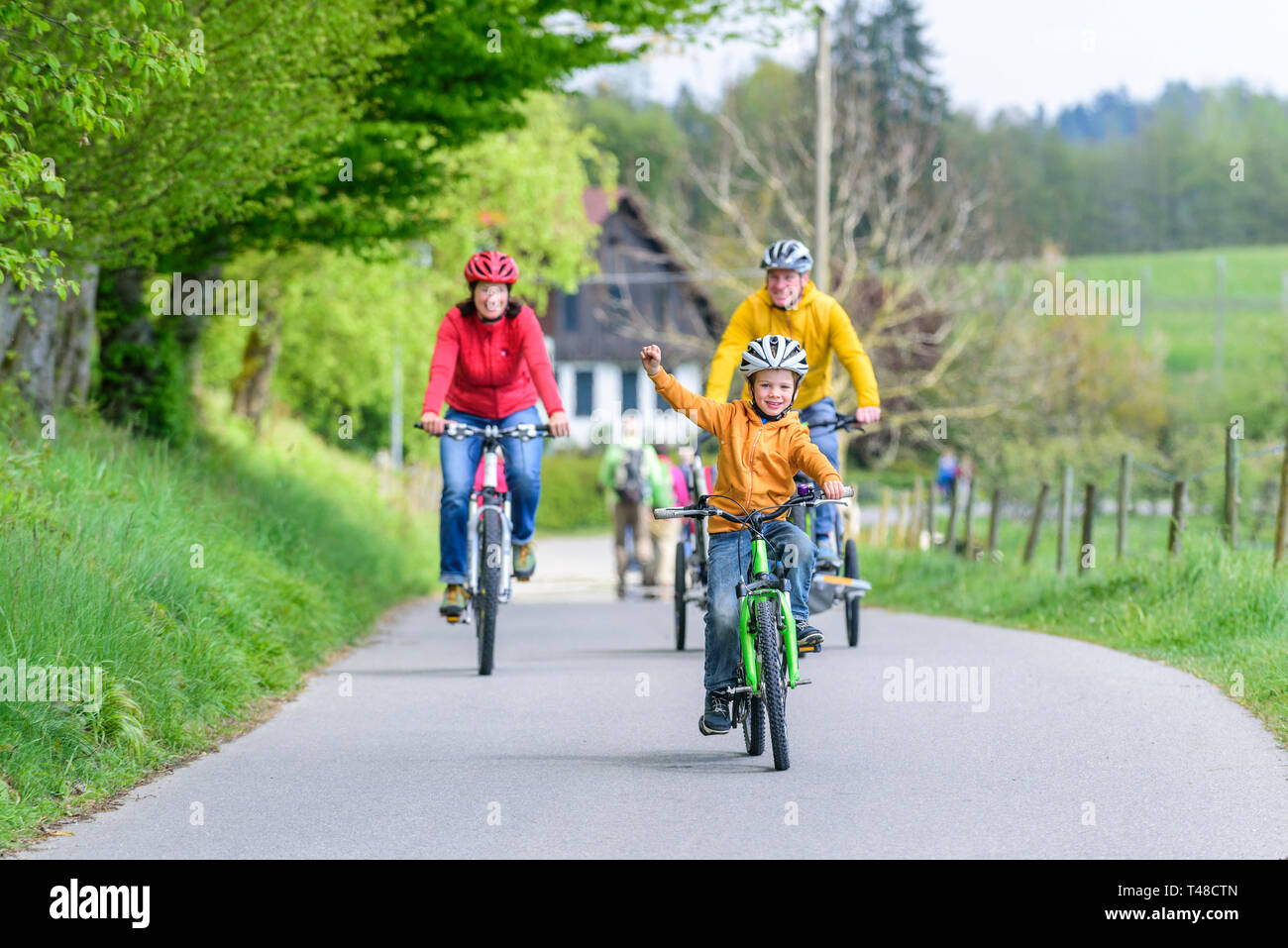 Young family having fun while cycling in springtime Stock Photo - Alamy