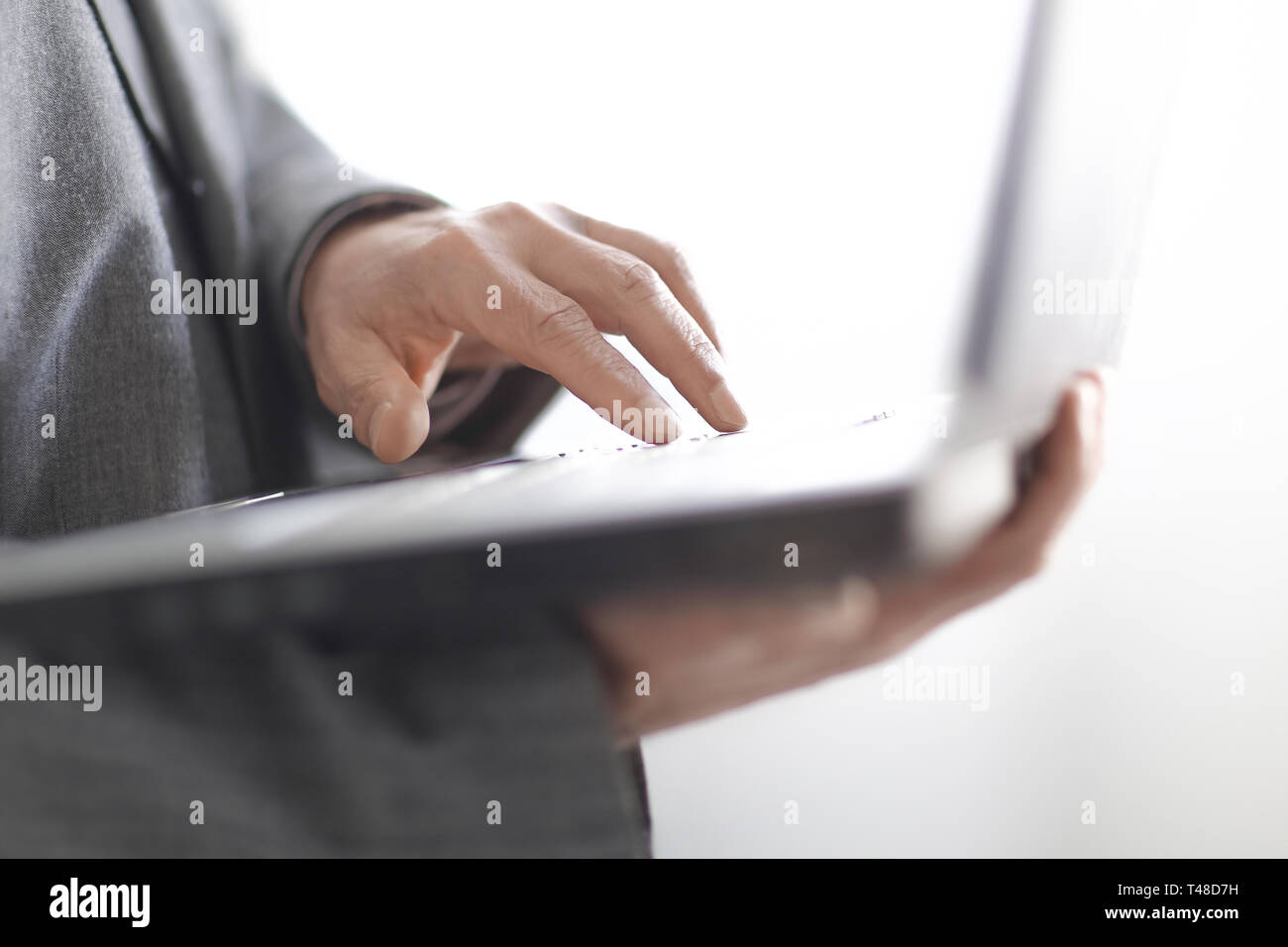 close up.businessman typing on a laptop keyboard.isolated on white ...