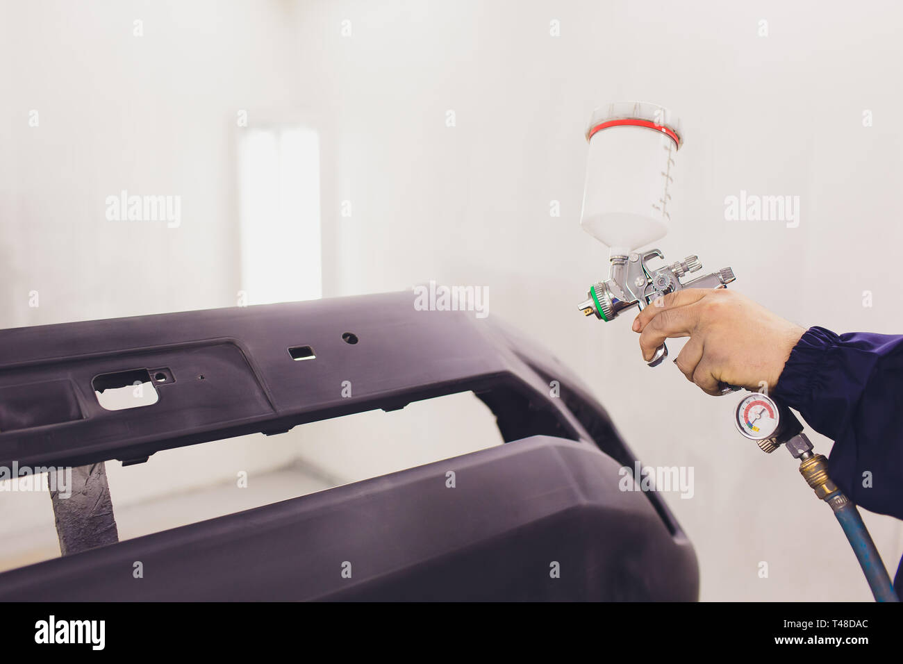 Automotive Paint. Mechanic Painting the Car in Auto Repair Shop Stock ...