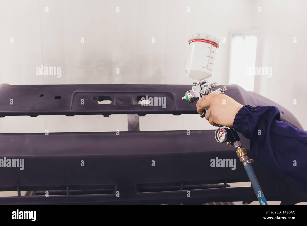 Automotive Paint. Mechanic Painting the Car in Auto Repair Shop Stock ...