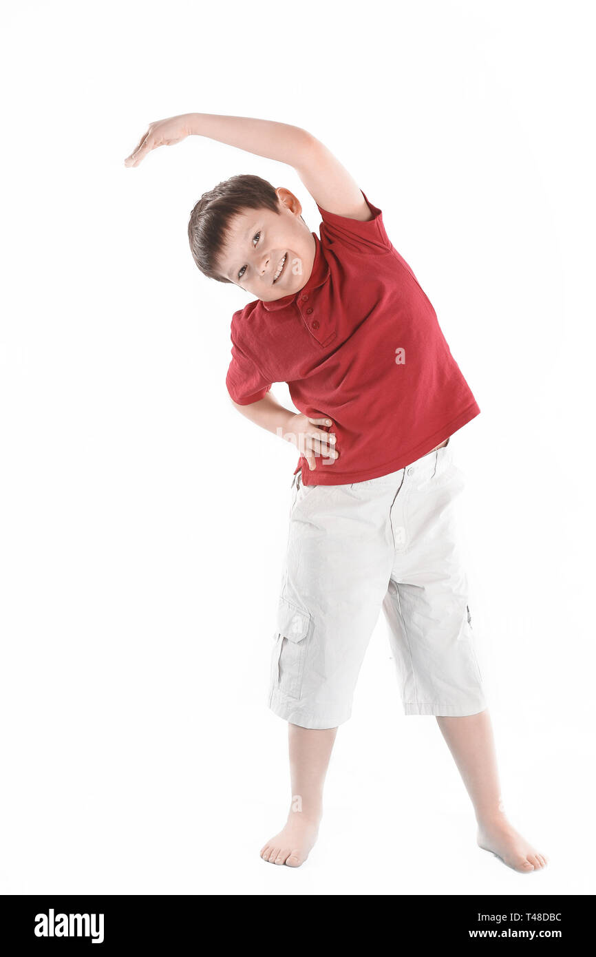 little boy performs an exercise to stretch the muscles.isolated on ...