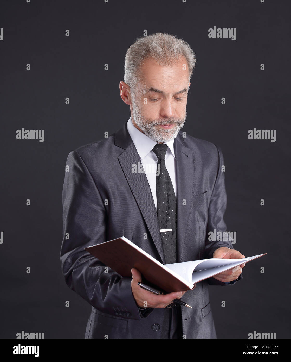 serious businessman signs a working document.isolated on black Stock ...
