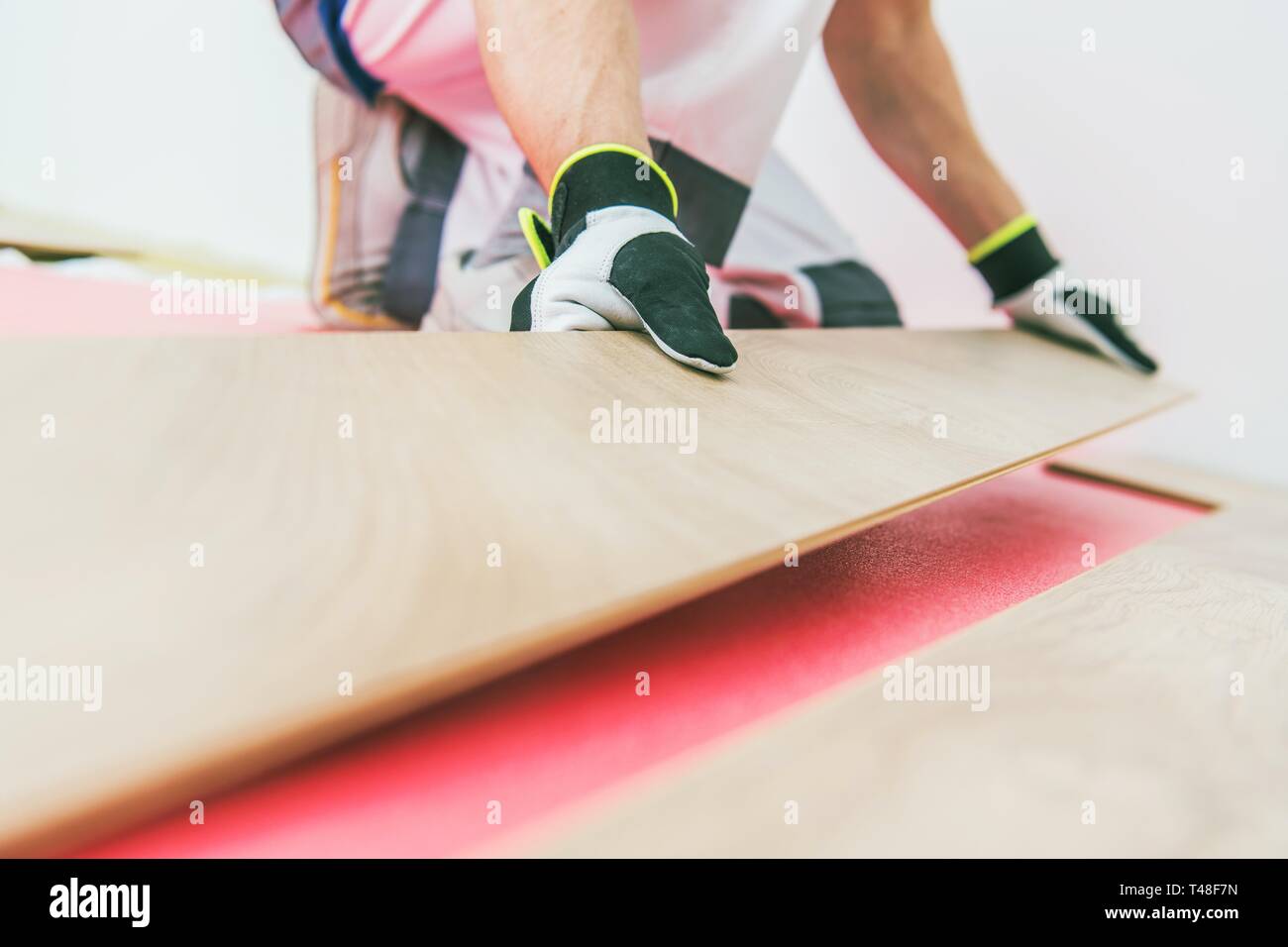 Wooden Floor Panel Installing by Professional Flooring Installer ...