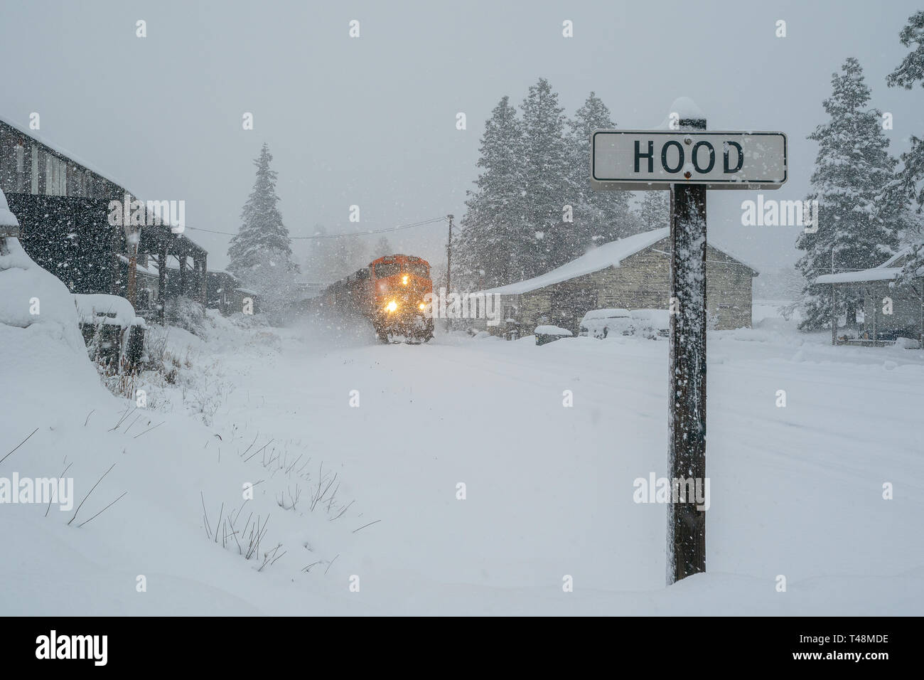 A train plows through the storm and abandon buildings Stock Photo - Alamy