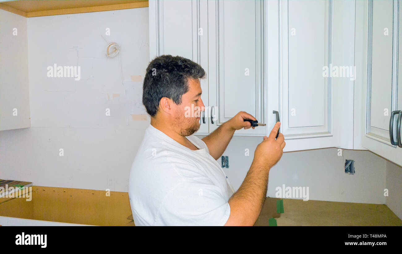 The Installing A Furniture Handle Process Of Assembling Kitchen Cabinet