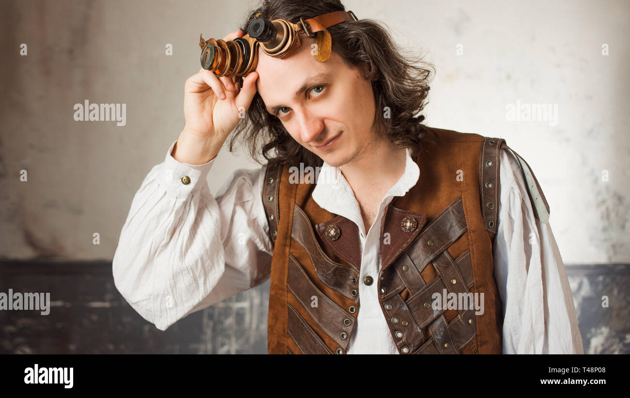 Steampunk pilot in a leather vest and flight glasses on his forehead ...