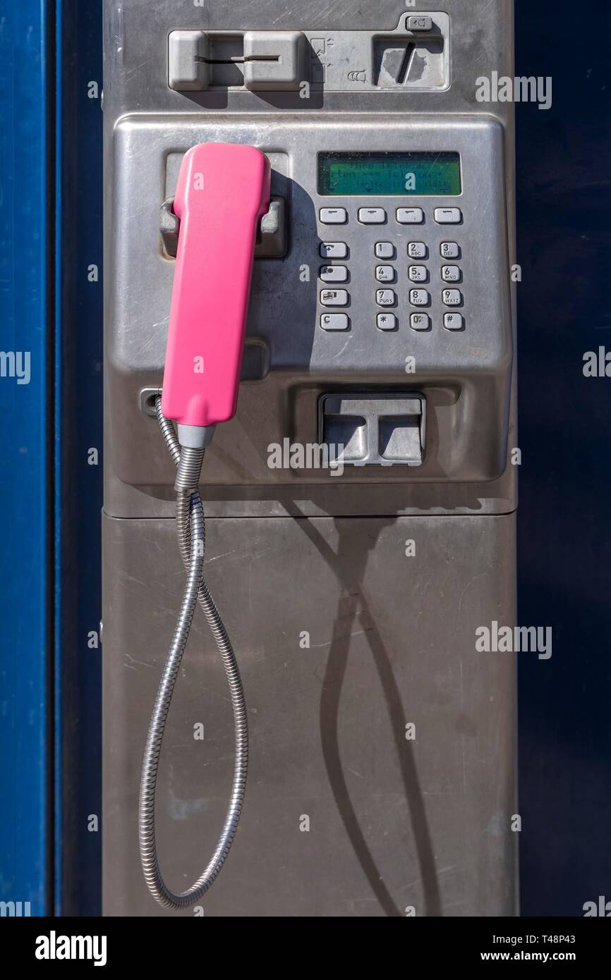 Public pay phone with pink handset, Bavaria, Germany Stock Photo - Alamy