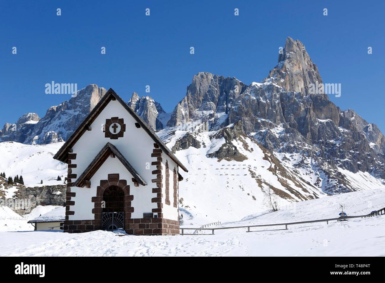 Chapel at the mountain pass Passo Rolle with snow, Palla Group ...