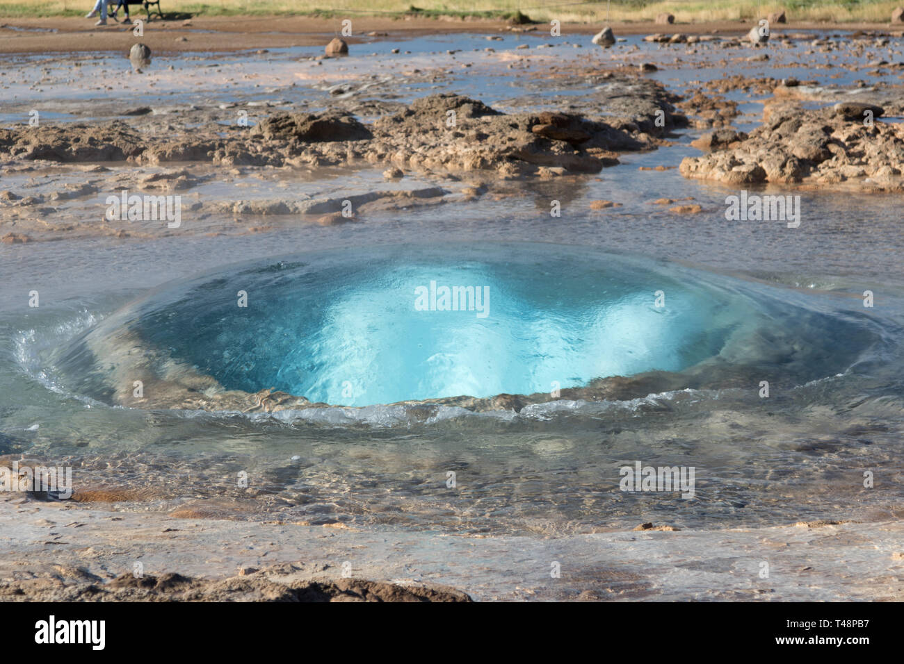 The turquoise blue boiling bubble of Strokkur Geyser In Iceland before ...