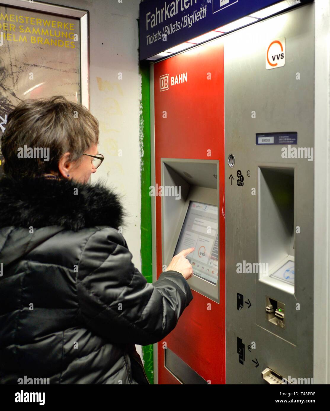 Older woman buys ticket at ticket machine hi-res stock photography and ...