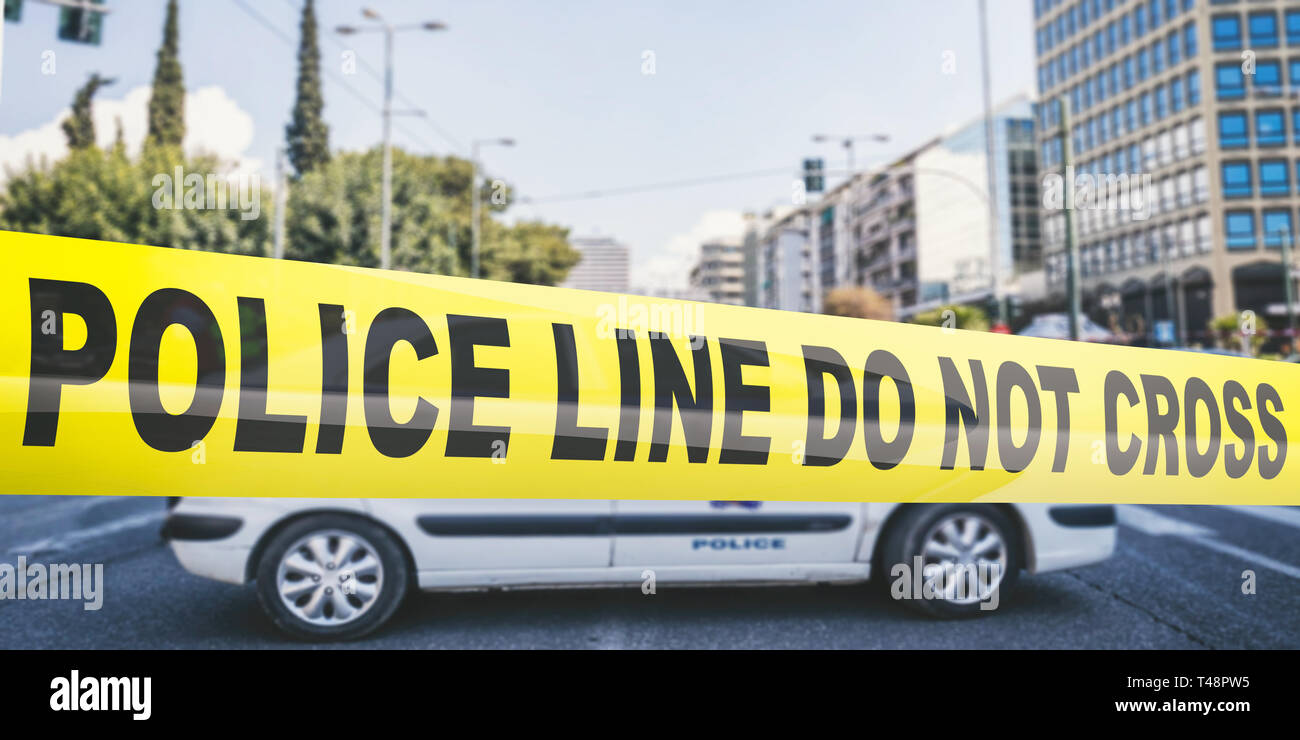 Police line on the street. Warning yellow tape, text police line do not ...