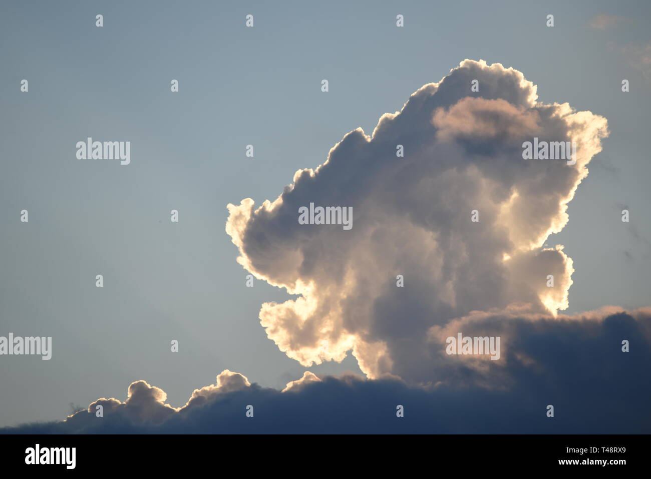 Huge towering cumulus clouds back and side lighting Stock Photo - Alamy