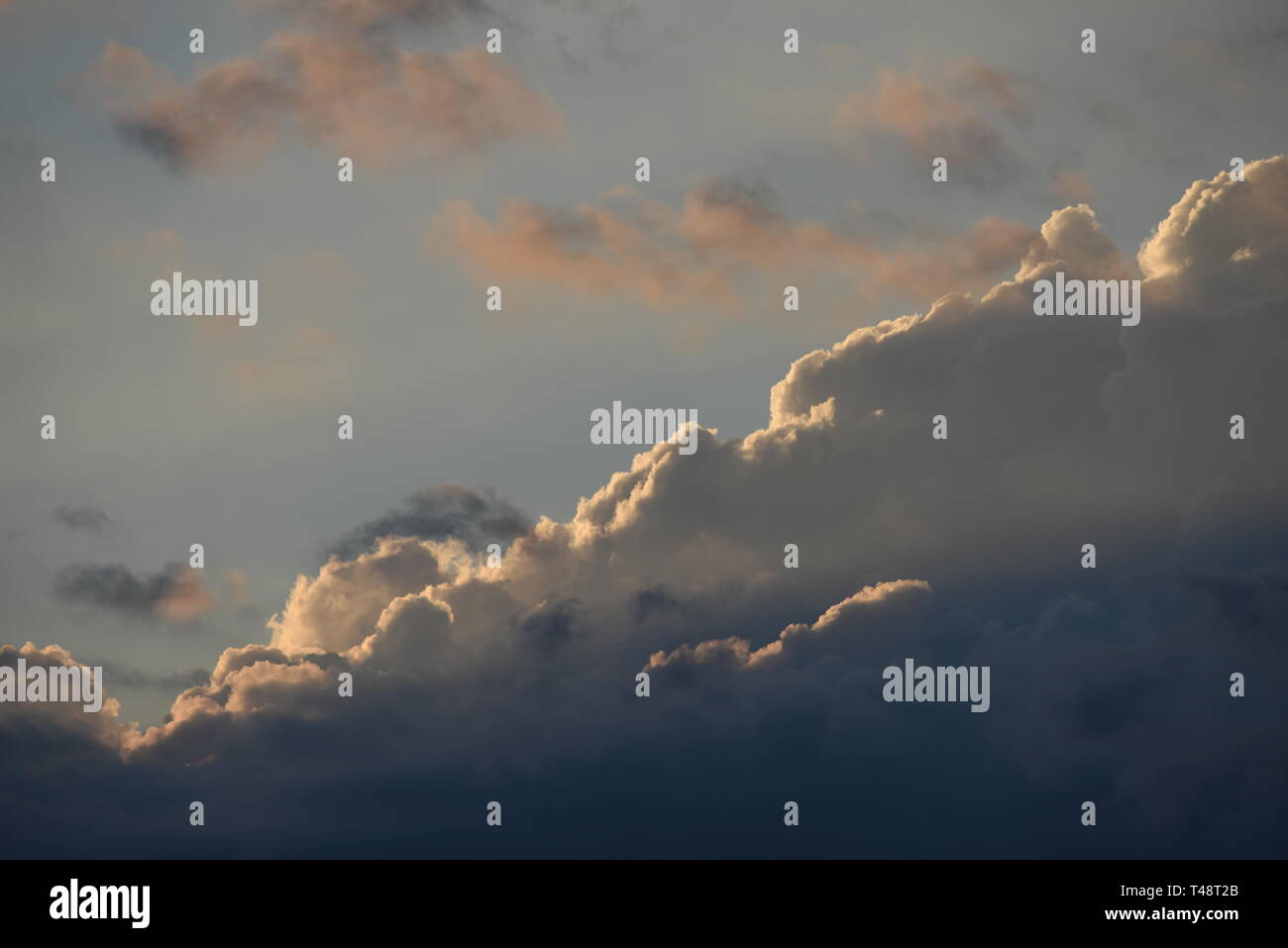 Huge towering cumulus clouds back and side lighting Stock Photo - Alamy