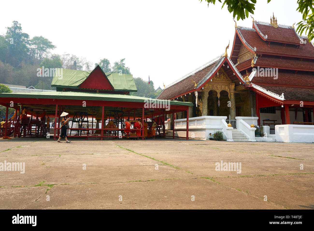 LUANG PRABANG, LAOS - APRIL 14, 2019. MONKS sit in temple at pi mai ...