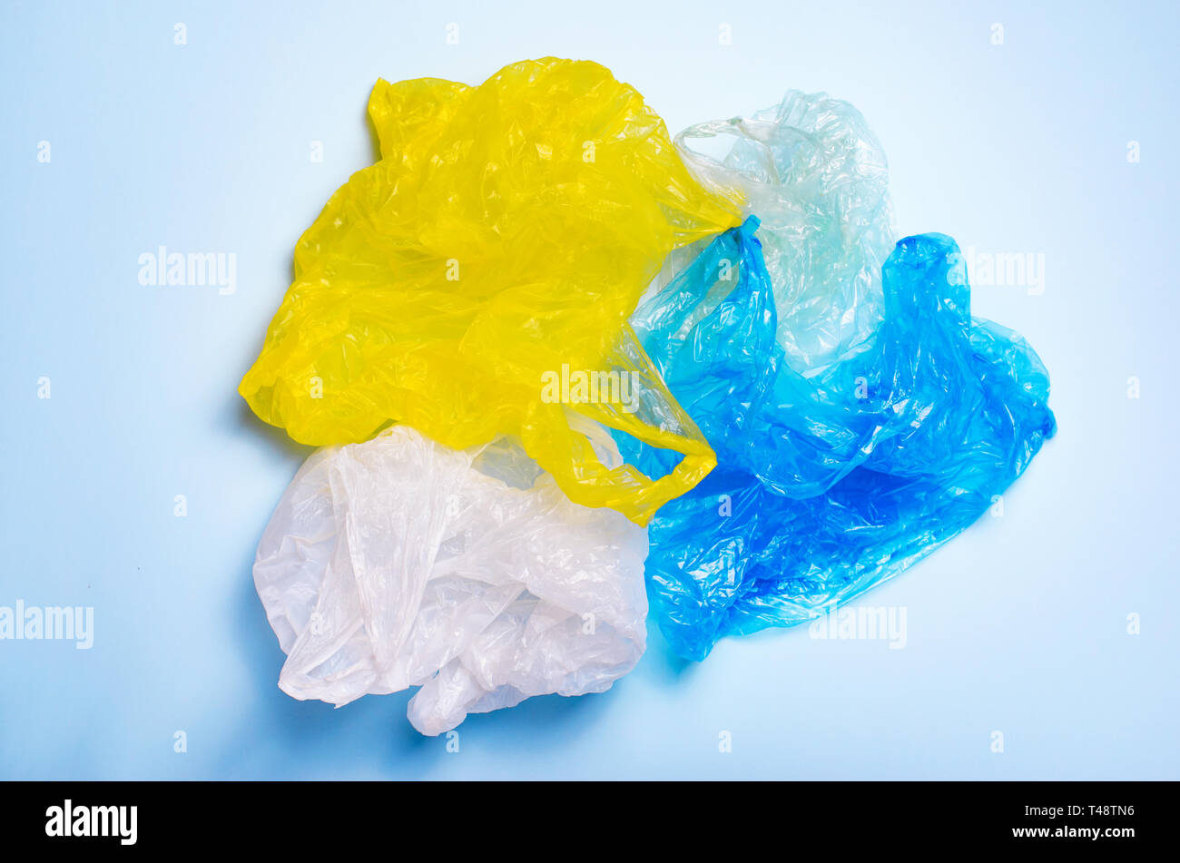 Plastic Bags on Light Blue Background, Recycle and Plastic Pollution ...
