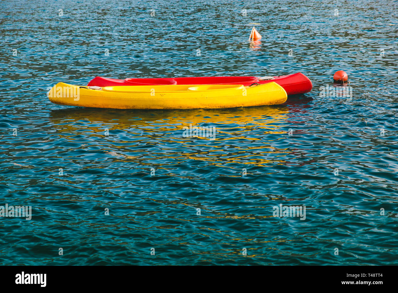 two kayaks red and yellow in water. summer leisure Stock Photo - Alamy