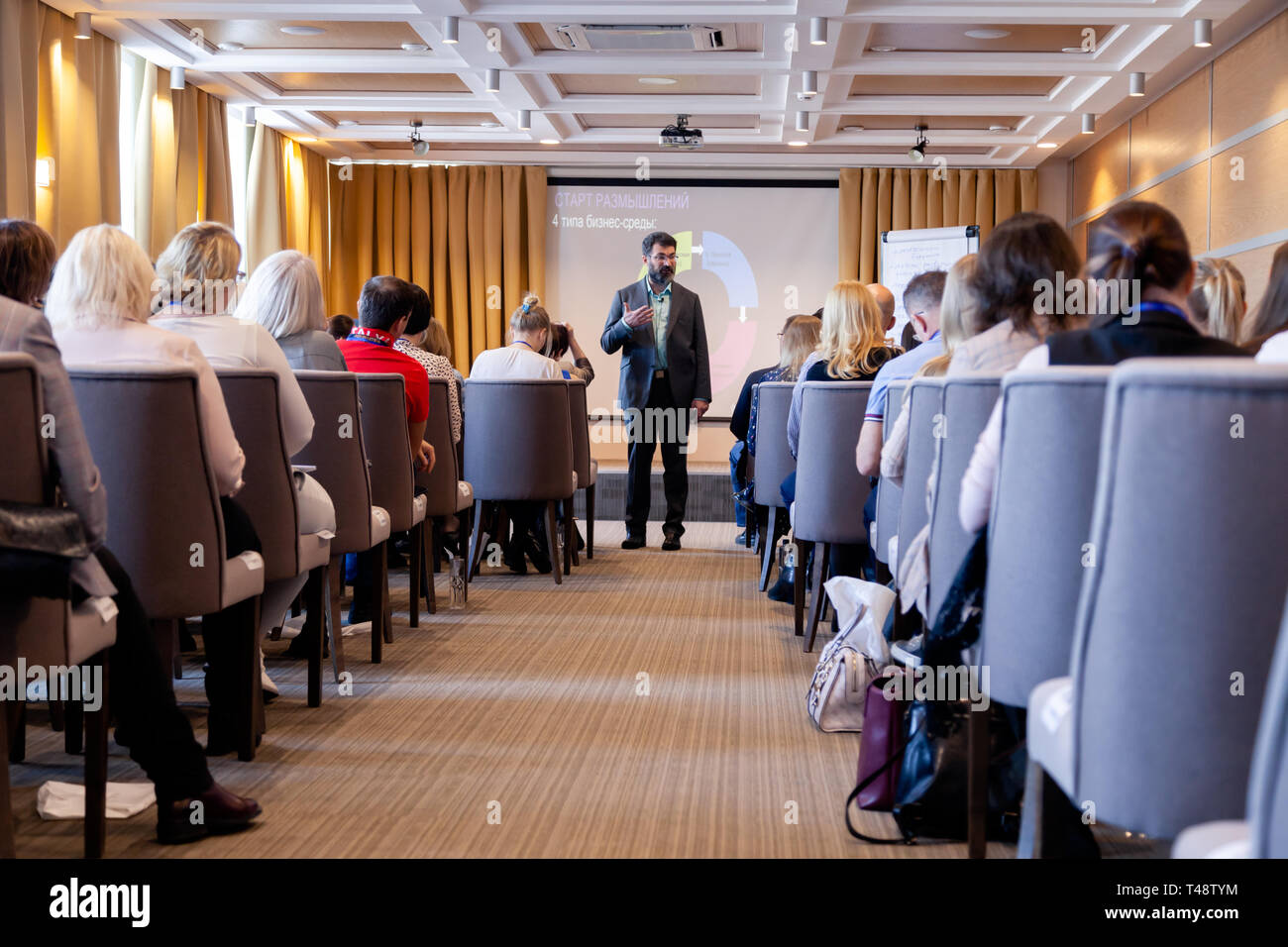 Speaker giving a talk at conference, presentation, business event ...