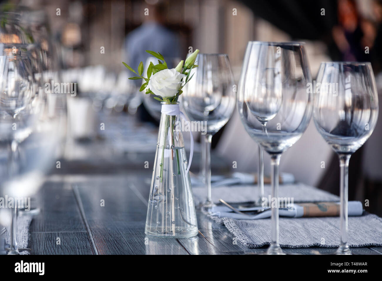 Transparent glass vase with bouquet of flowers against background of ...