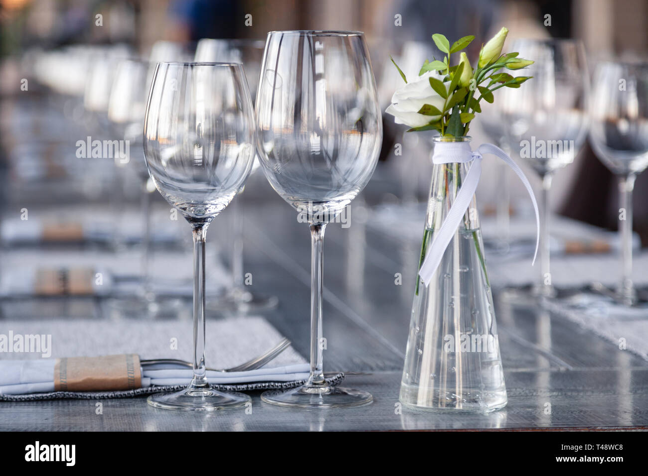 Transparent glass vase with bouquet of flowers against background of ...