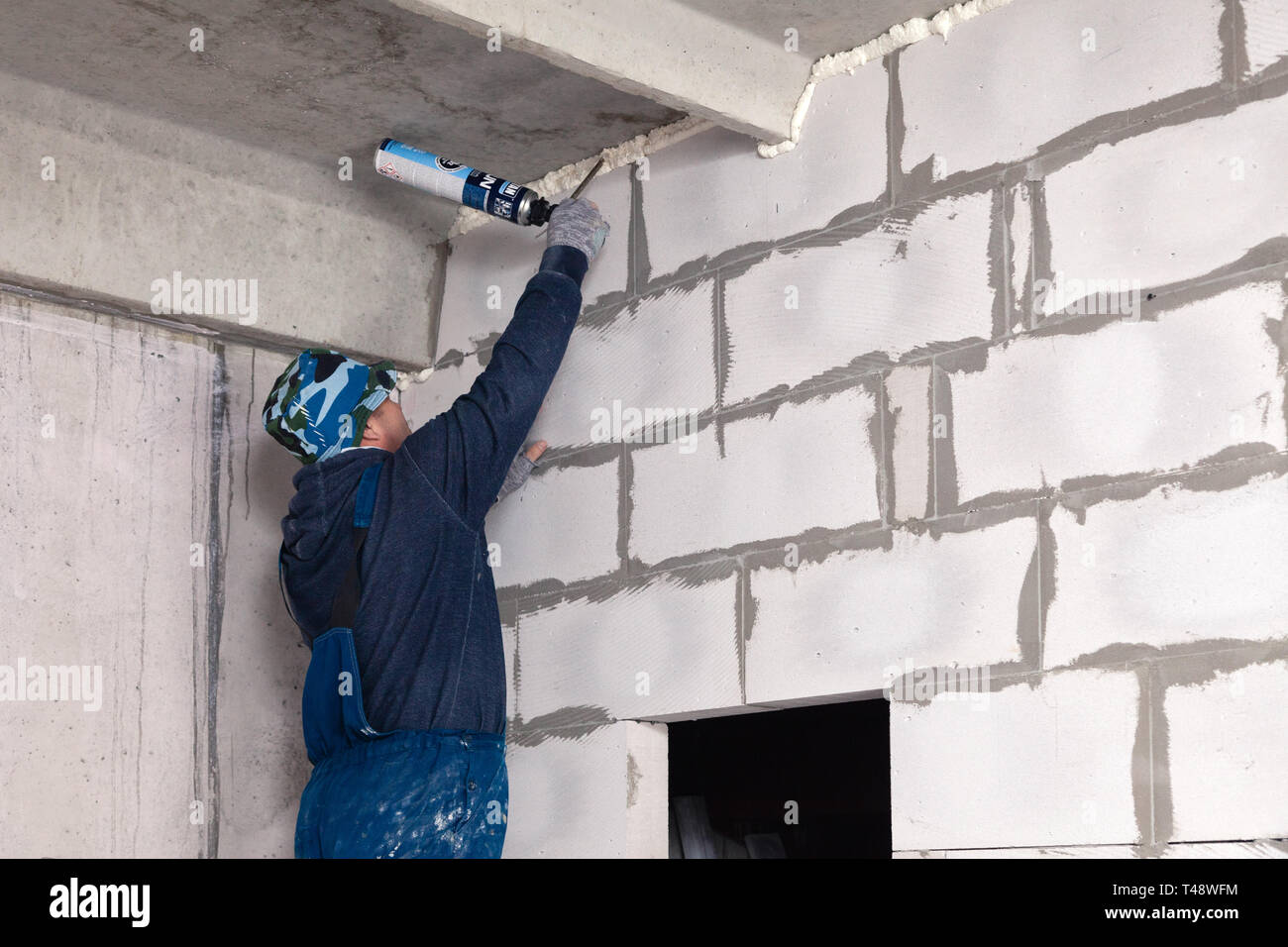 Russia Kemerovo 2019-03-02 builder working, wall aerated concrete with ...