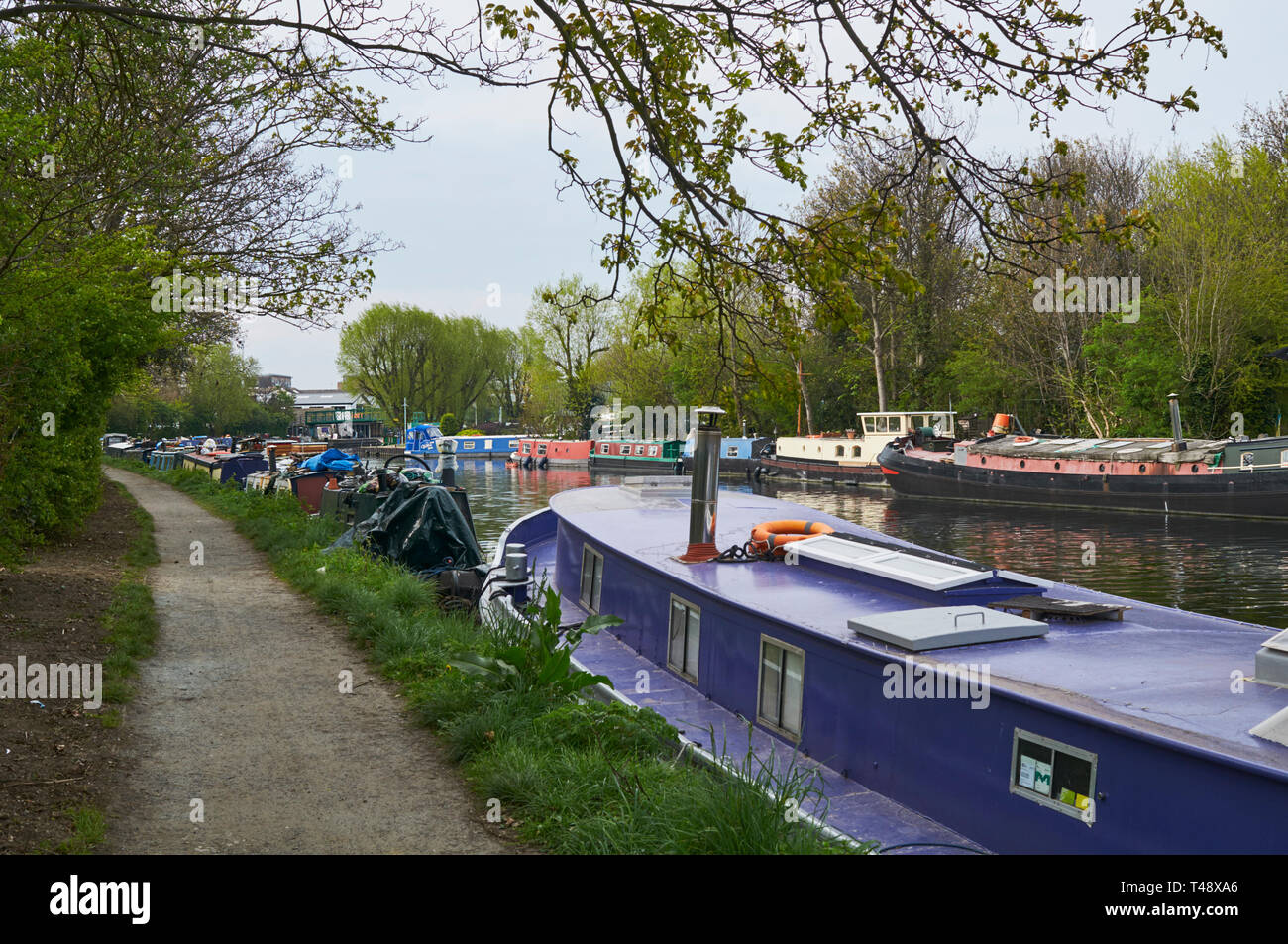 Towpath and narrowboats along the River Lea near Upper Clapton, North ...