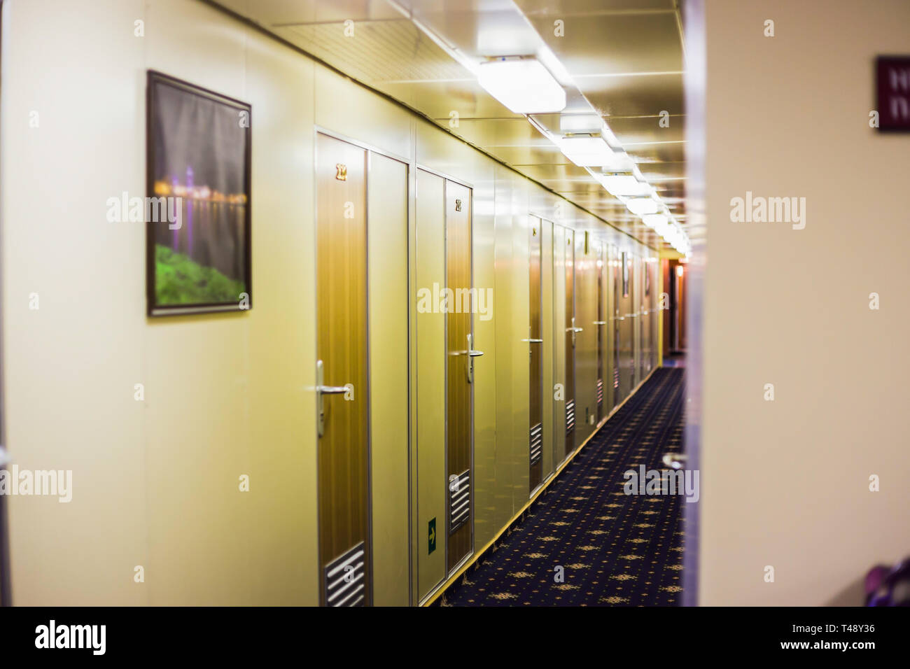 Long corridor of cruise ship, yellow and brown walls and doors Stock ...
