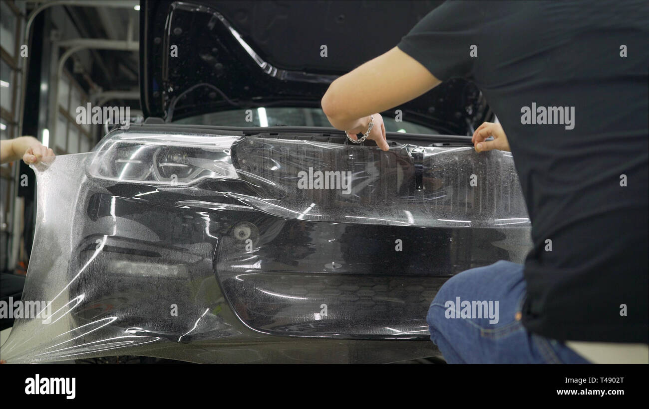 Deteyling car. Sticker protective film on the bumper of the car Stock ...