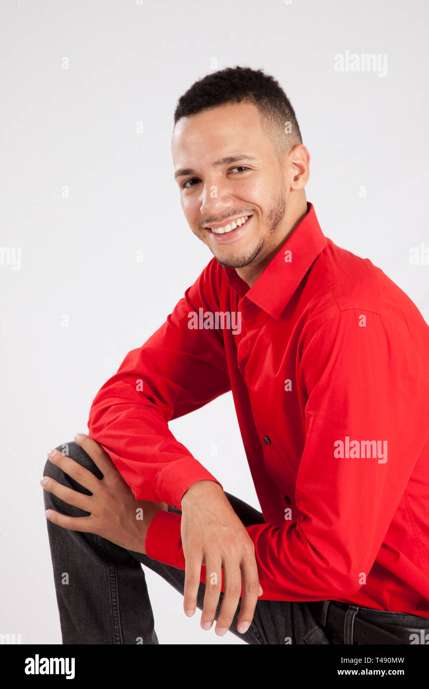 Happy Black man standing with one leg on a table Stock Photo - Alamy