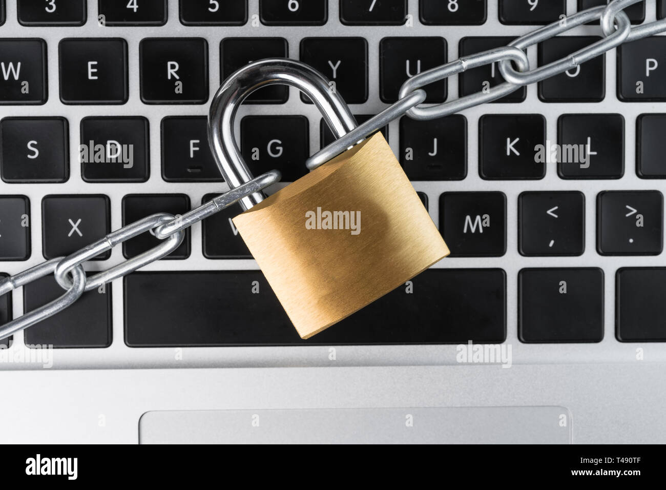 Padlock with chain on a laptop computer keyboard. Cyber security ...