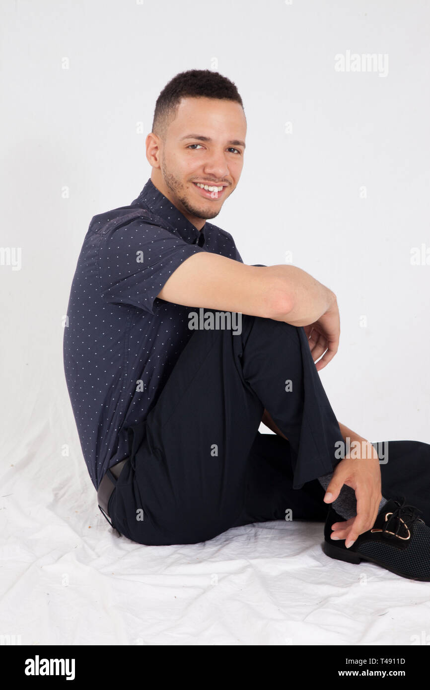 Handsome man sitting with a big smile Stock Photo - Alamy