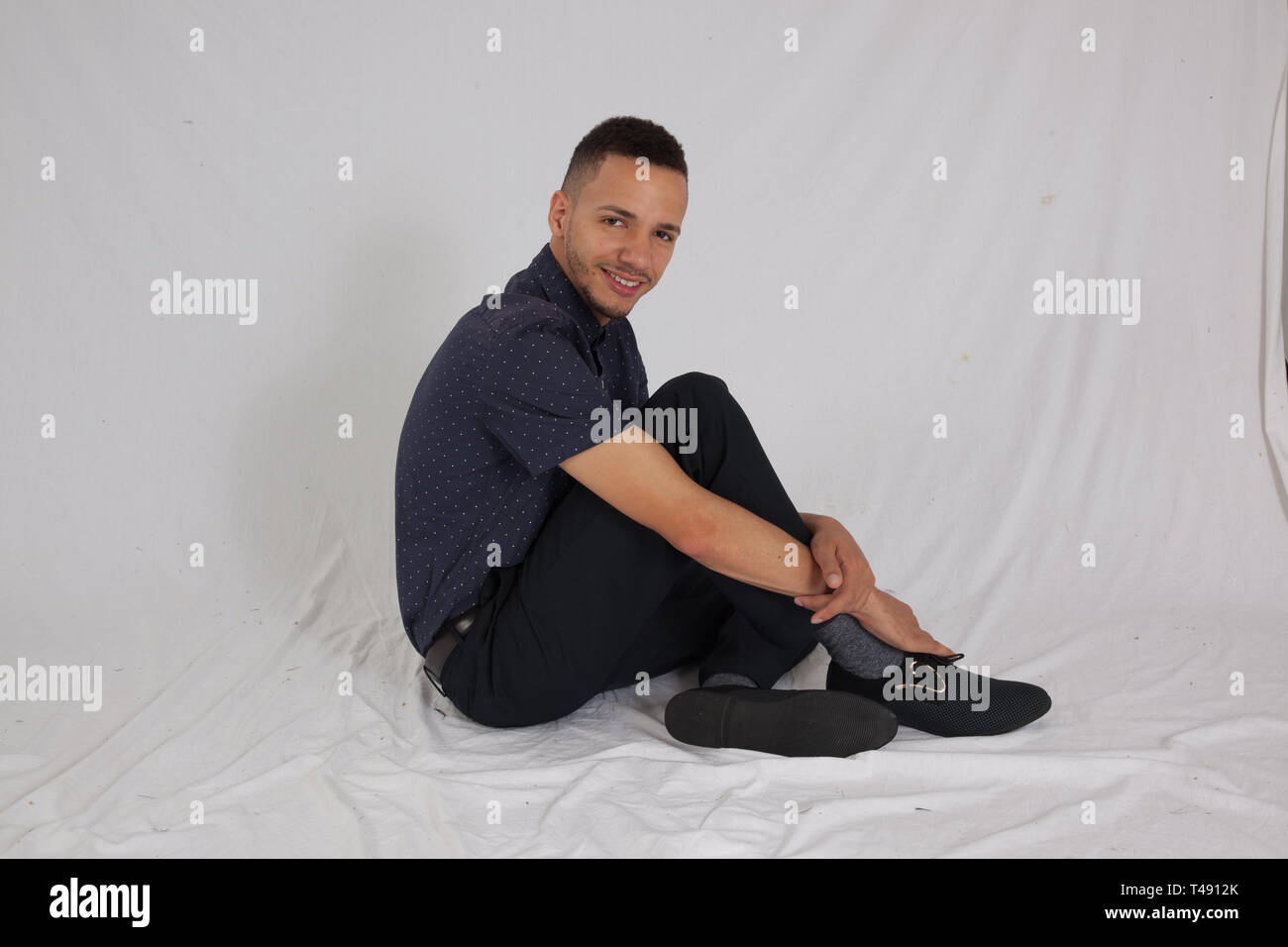 Handsome man sitting with a big smile Stock Photo - Alamy