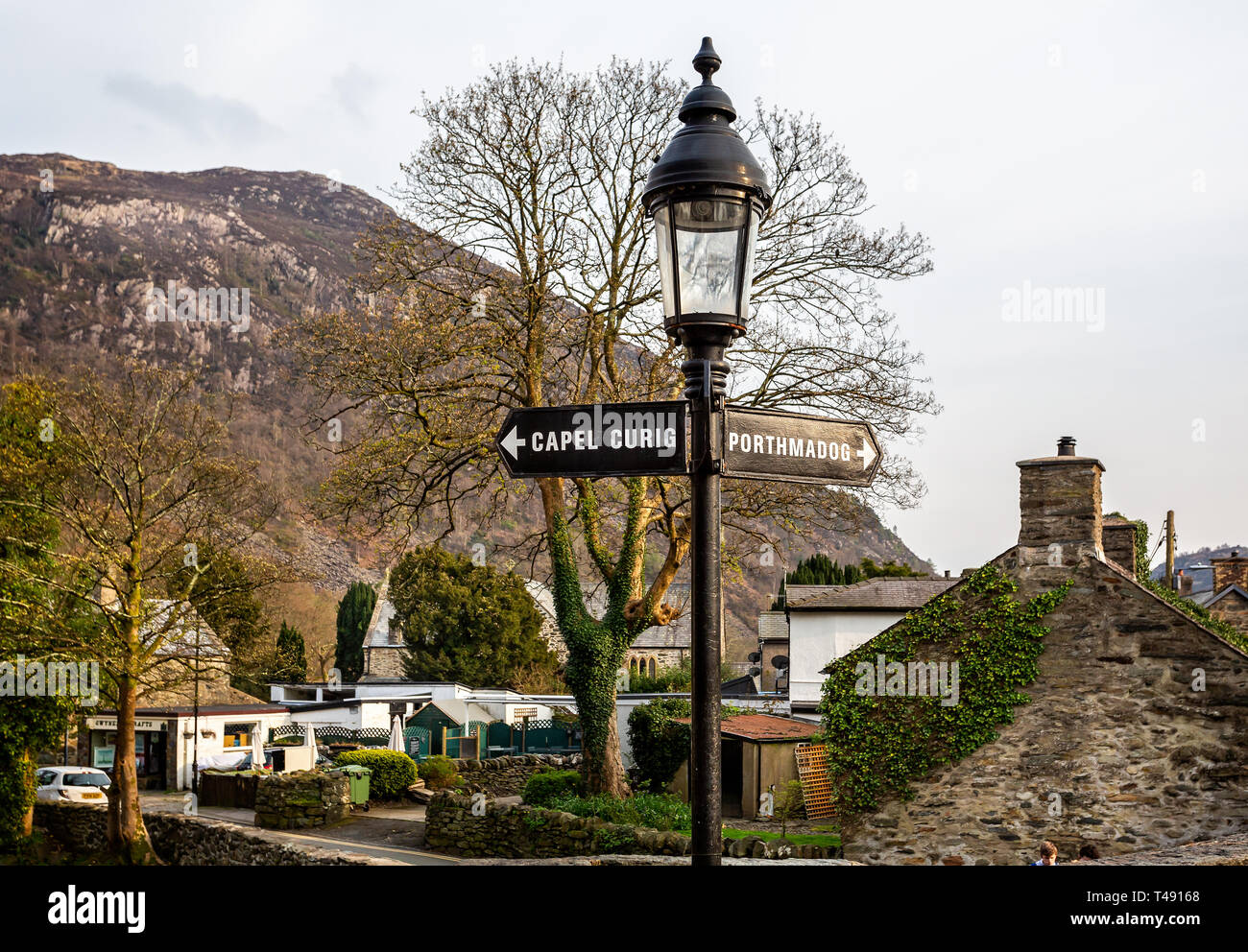 Lamp with signpost to porthmadog & Capel Curig on River bridge in ...