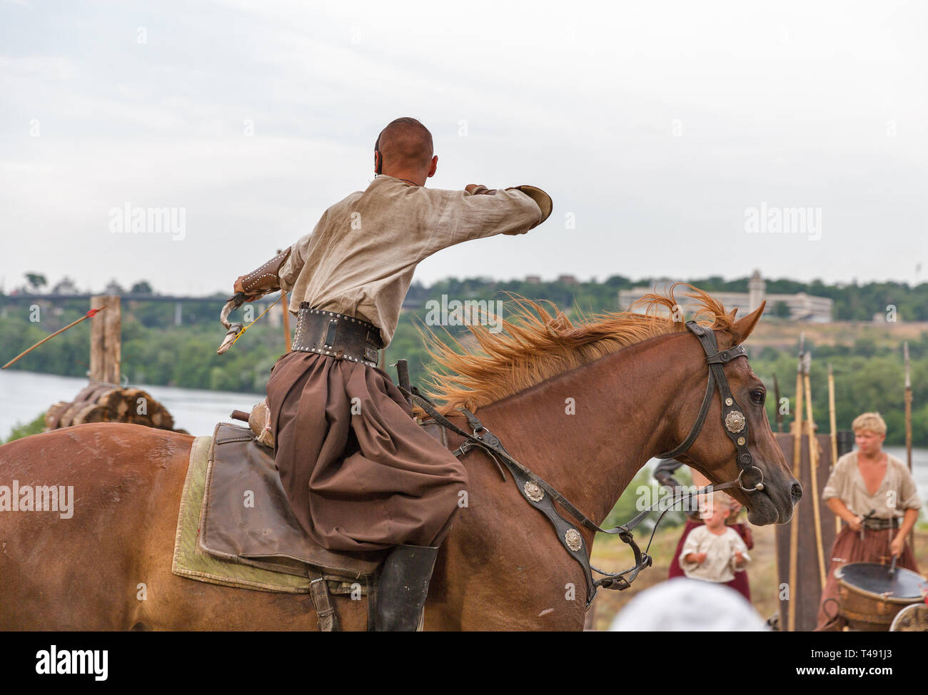 KHORTYTSIA, UKRAINE - JULY 03, 2018: Young Ukrainian Cossack archer ...