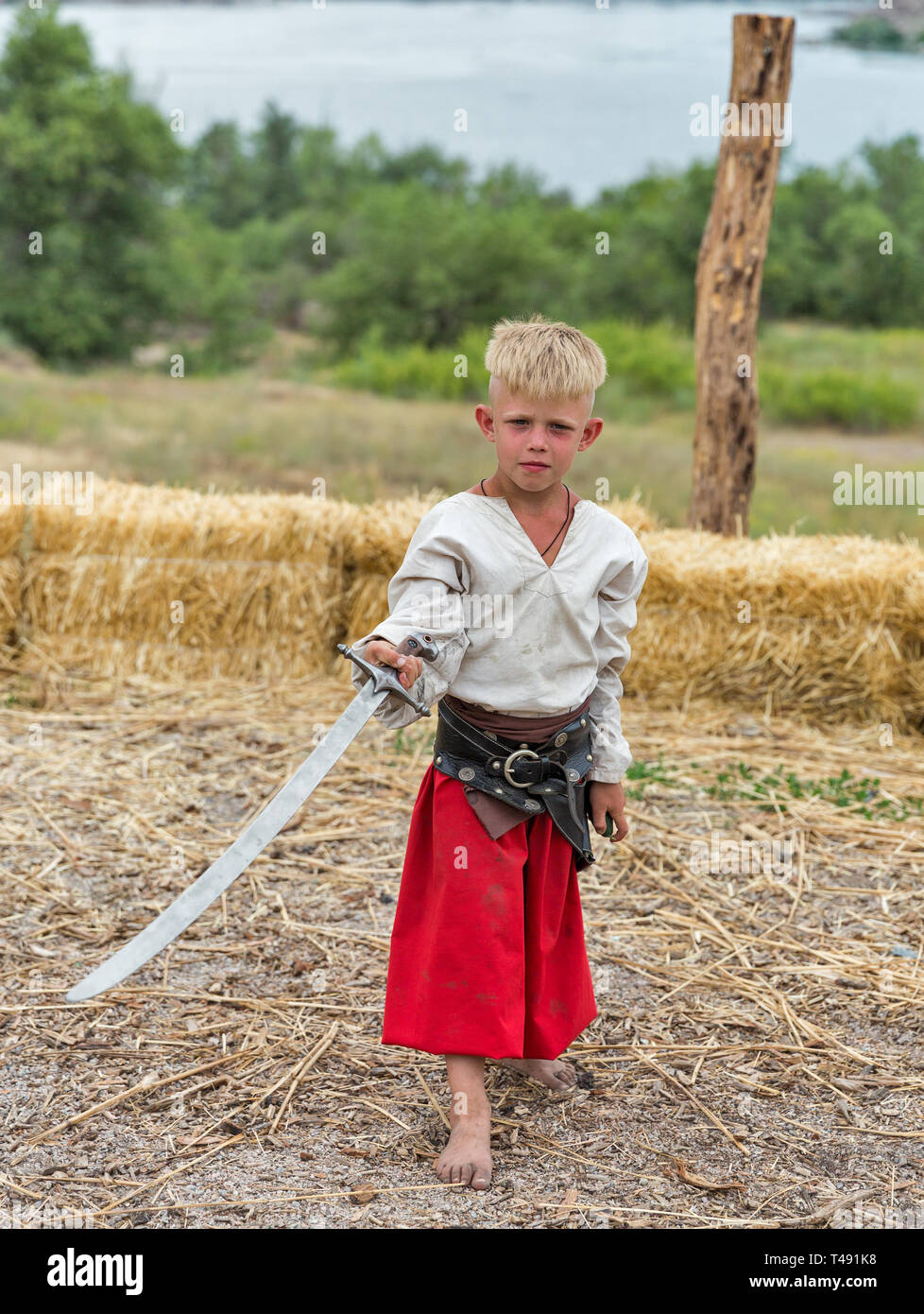 KHORTYTSIA, UKRAINE - JULY 03, 2018: Young boy Ukrainian Cossack with ...