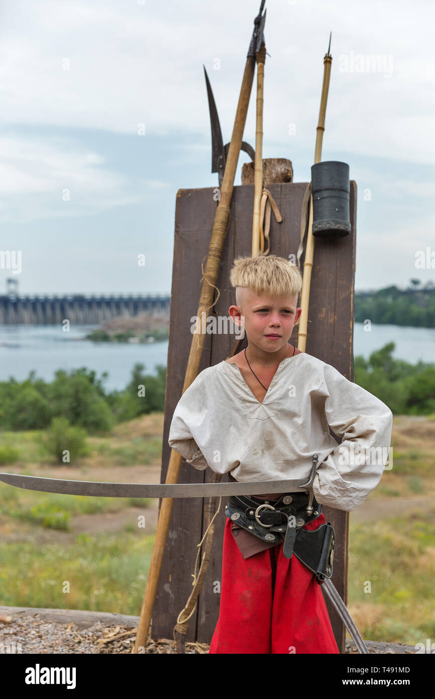 KHORTYTSIA, UKRAINE - JULY 03, 2018: Young boy Ukrainian Cossack with ...