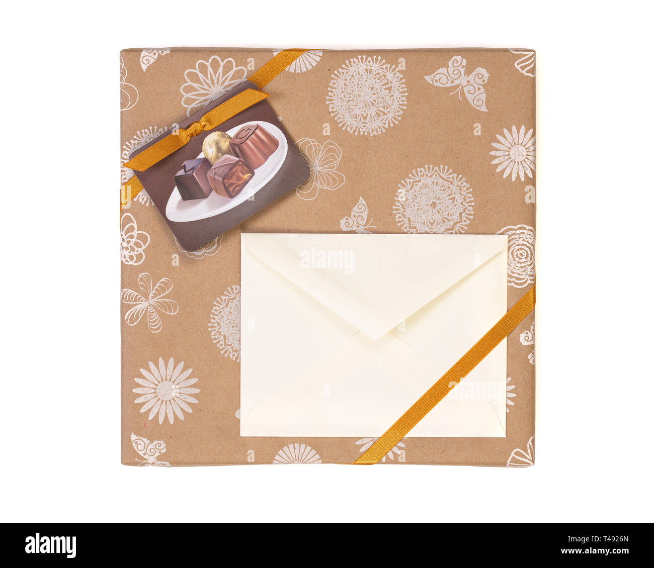 Gift wrapped box with chocolate candies and golden tape on a white ...