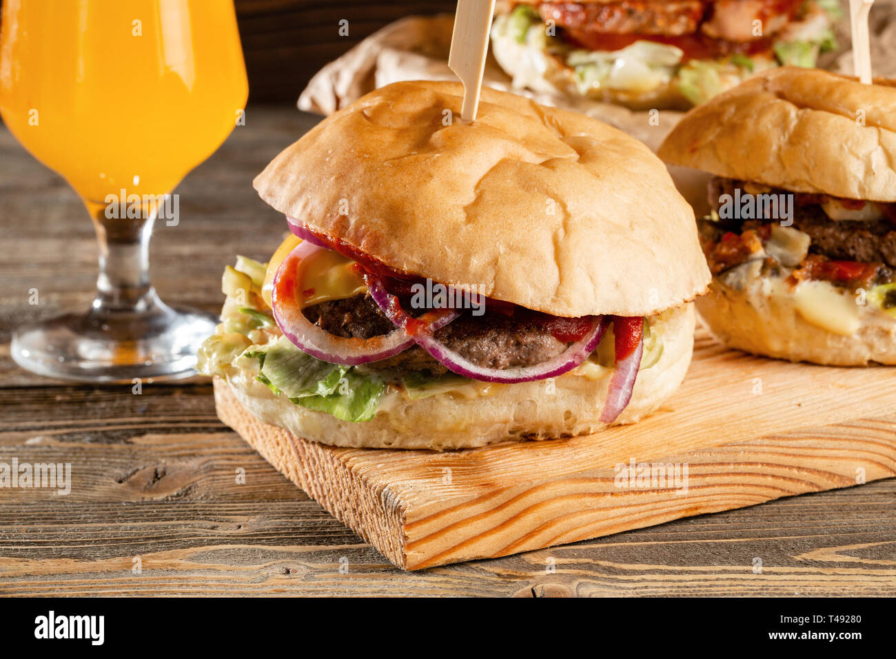 Three big burger with meat cooked on BBQ coal. Lunch with Glass of ...