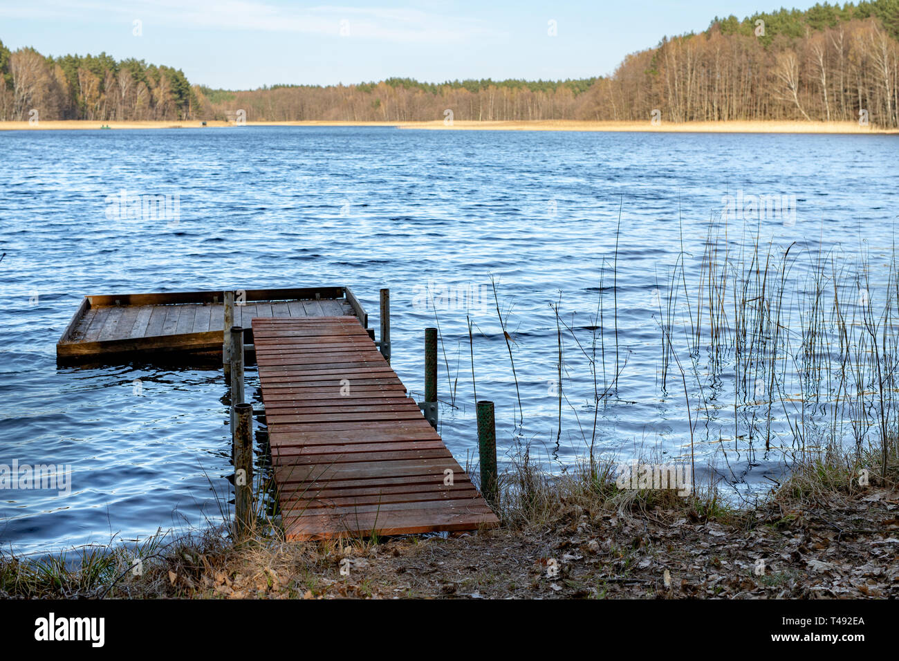 A wooden fishing bridge over a small lake. A place to catch fish ...