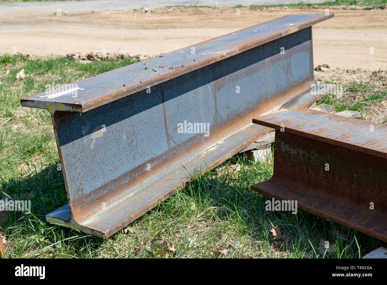 Large steel I-sections on the construction site. Poorly stored building ...