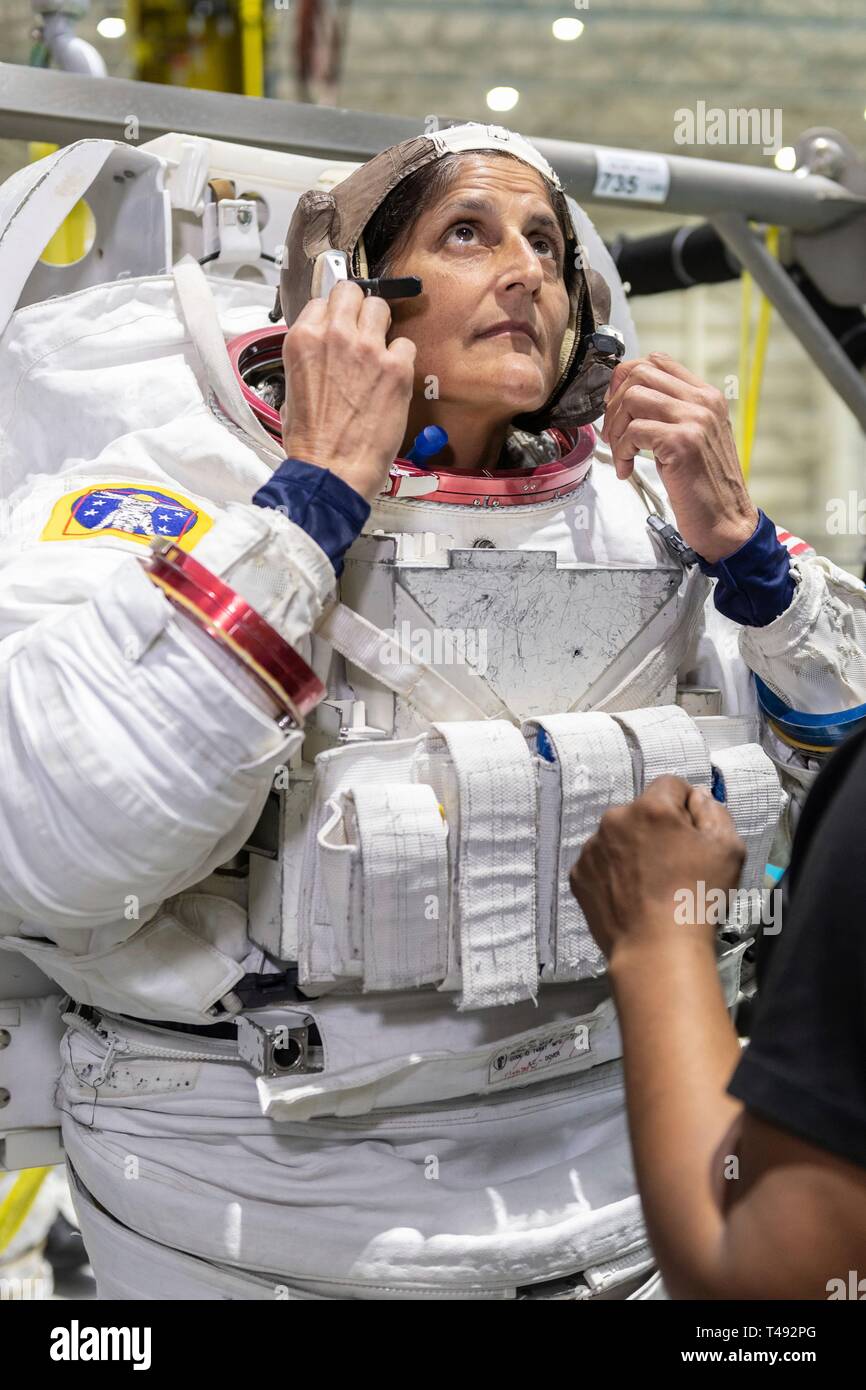Boeing Commercial Crew Program astronaut Suni Williams is assisted with ...