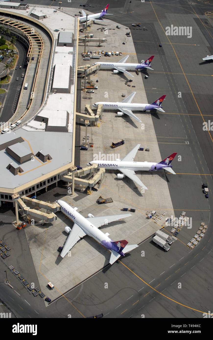 A portrait aerial view of jet airliners at the gates at a major airport ...