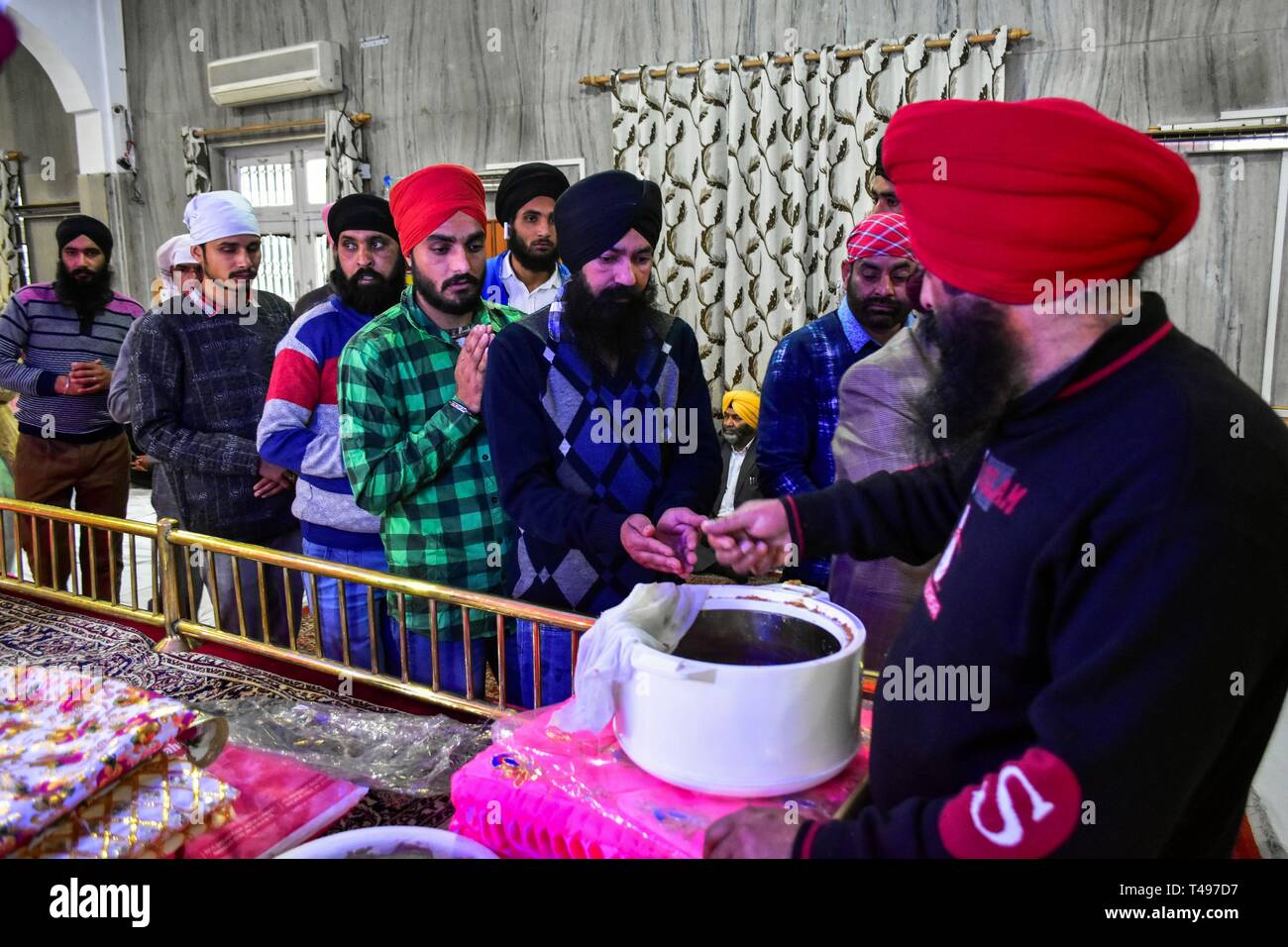 Distributing prasad hi-res stock photography and images - Alamy