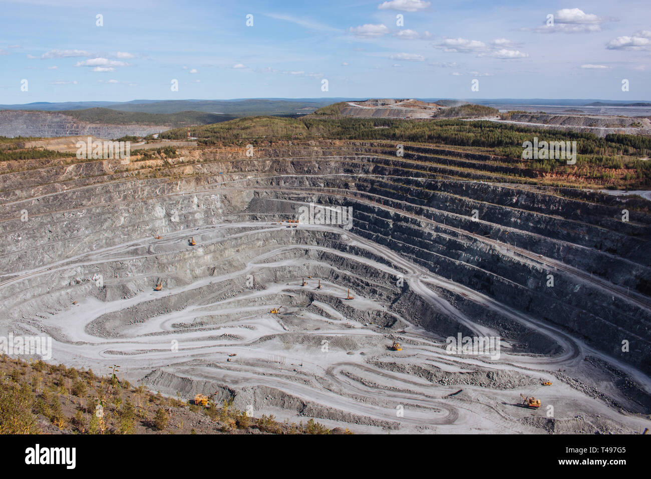 Aerial view industrial of opencast mining quarry with lots of machinery ...