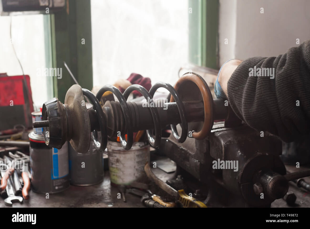 mechanic working on used car shock absorber for replacement Stock Photo ...
