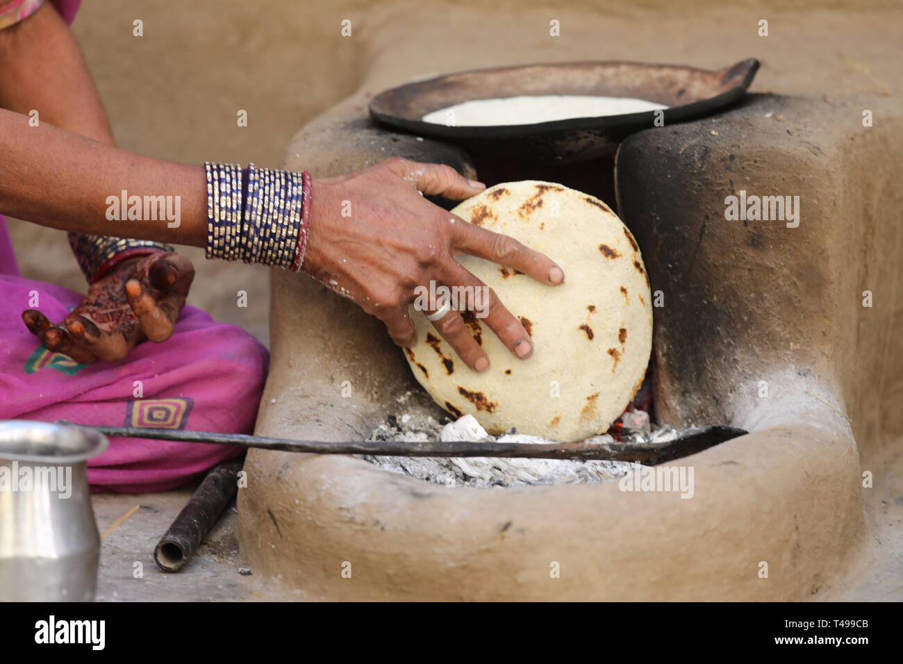 Indian Rajasthani woman cooking chapati --- chapatti indian bread ...