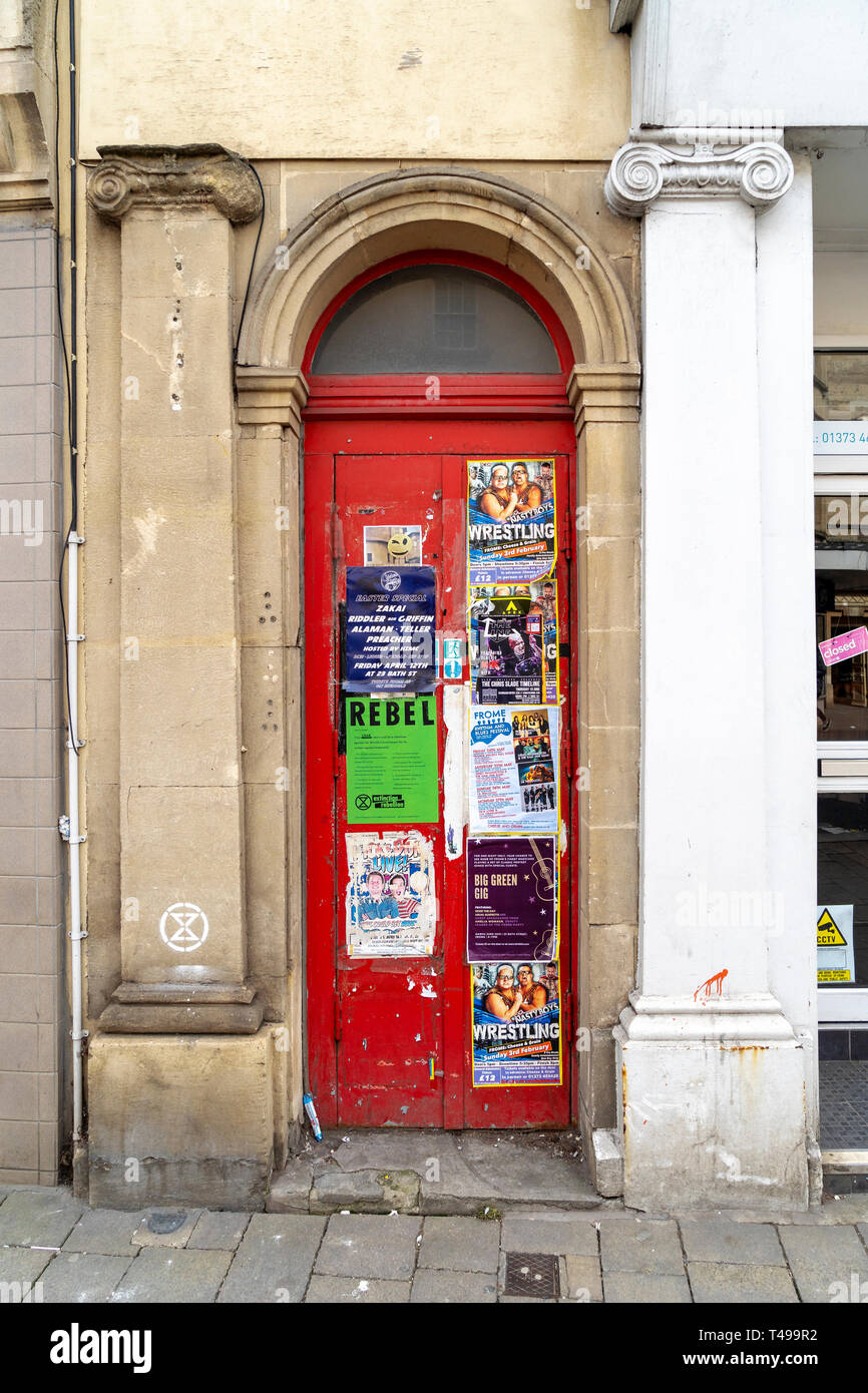 Red door with advertising posters and flyers attached Stock Photo - Alamy