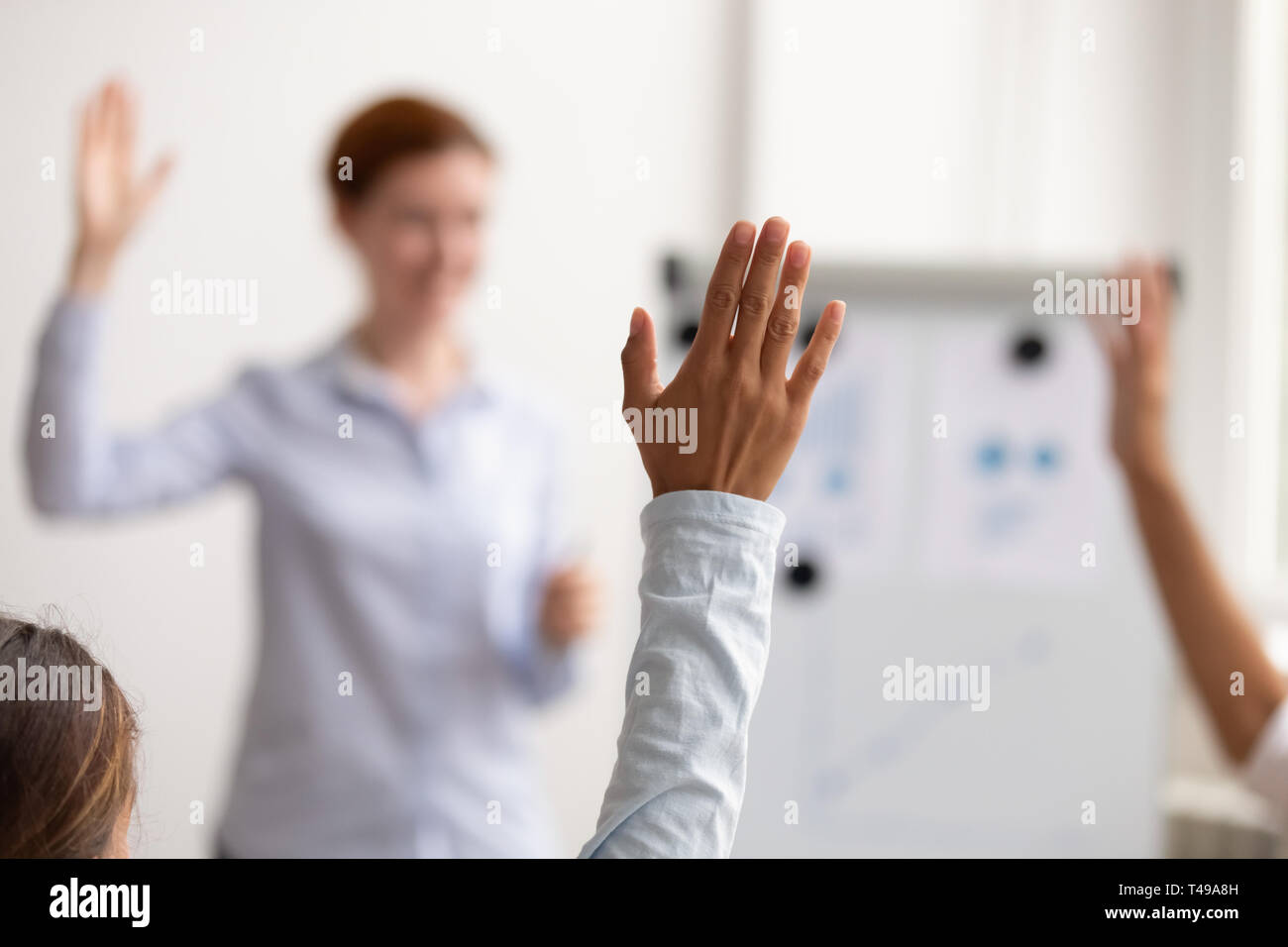 Business people raise hands up engaged in voting at conference Stock ...